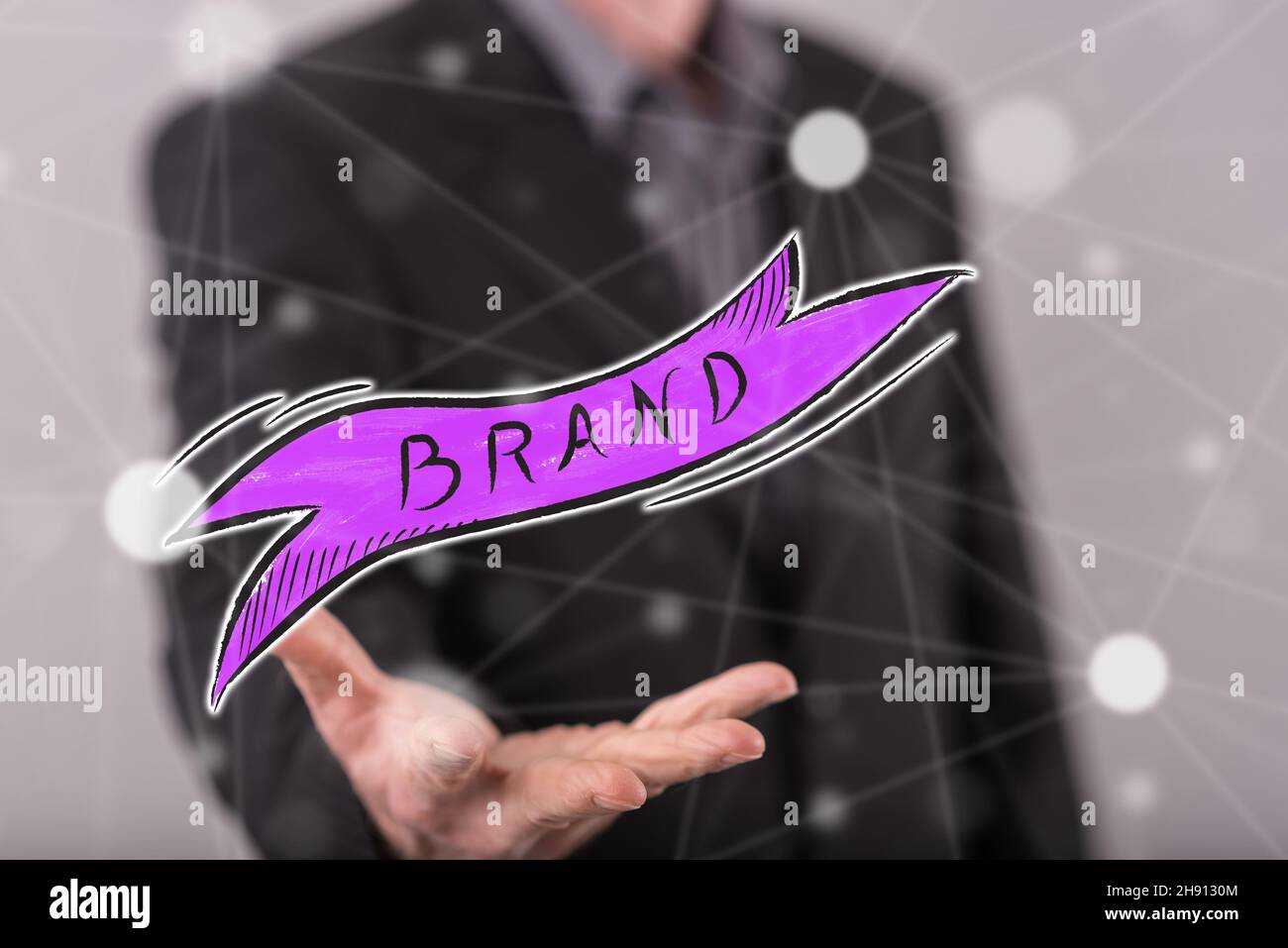 Brand concept above the hand of a man in background Stock Photo - Alamy