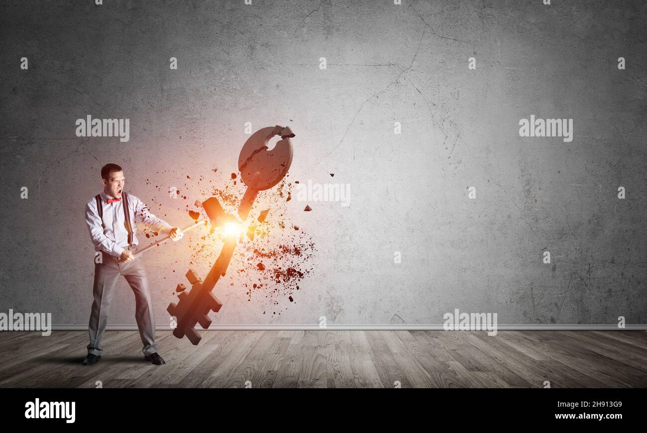 Breaking through access concept with man in room crashing concrete key ...