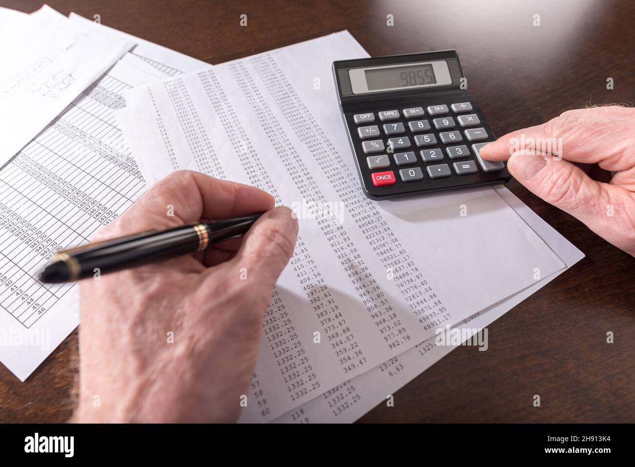Male hand using calculator for analyze financial data Stock Photo - Alamy