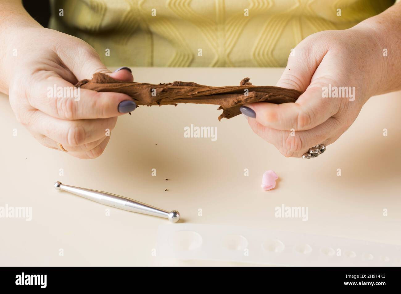 The master stretches polymer clay before starting modeling and making ...