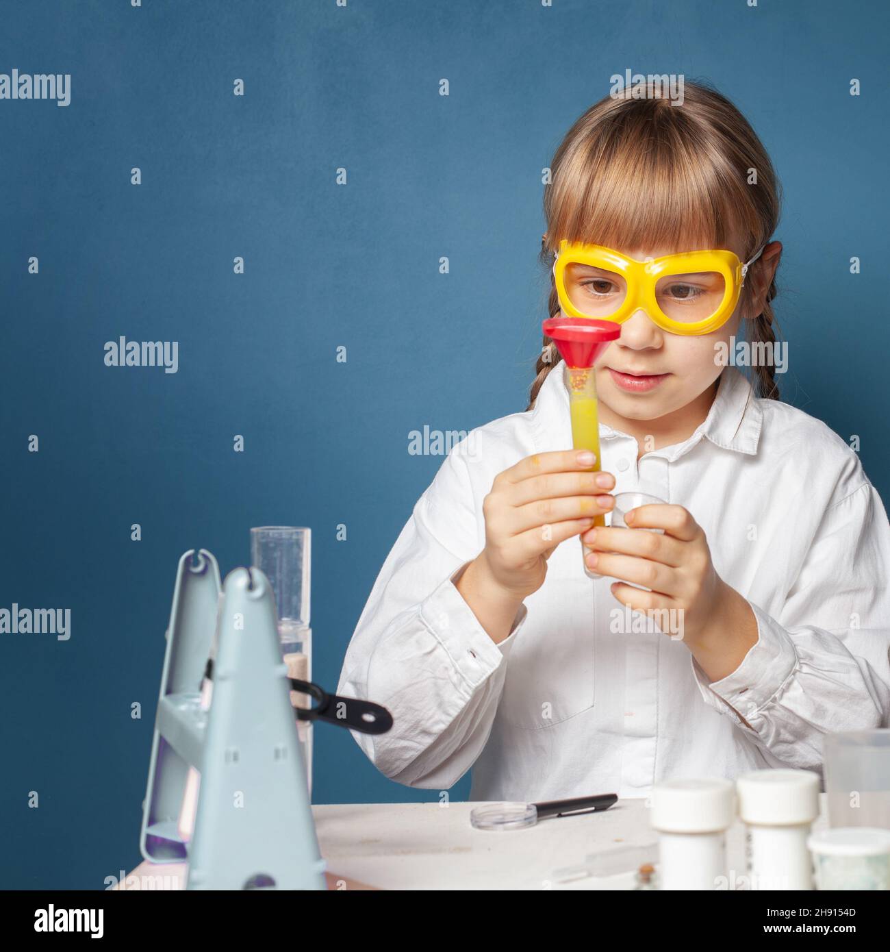 Smiling girl doing a science experiment for school Stock Photo - Alamy