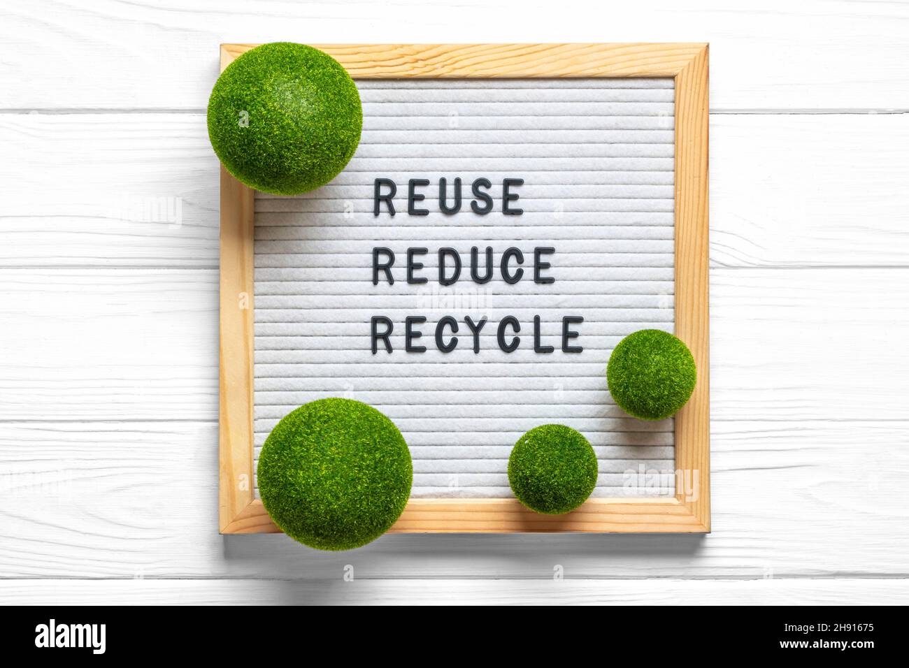 Felt board with quote text Reuse, Reduce, Recycle on white wooden table ...