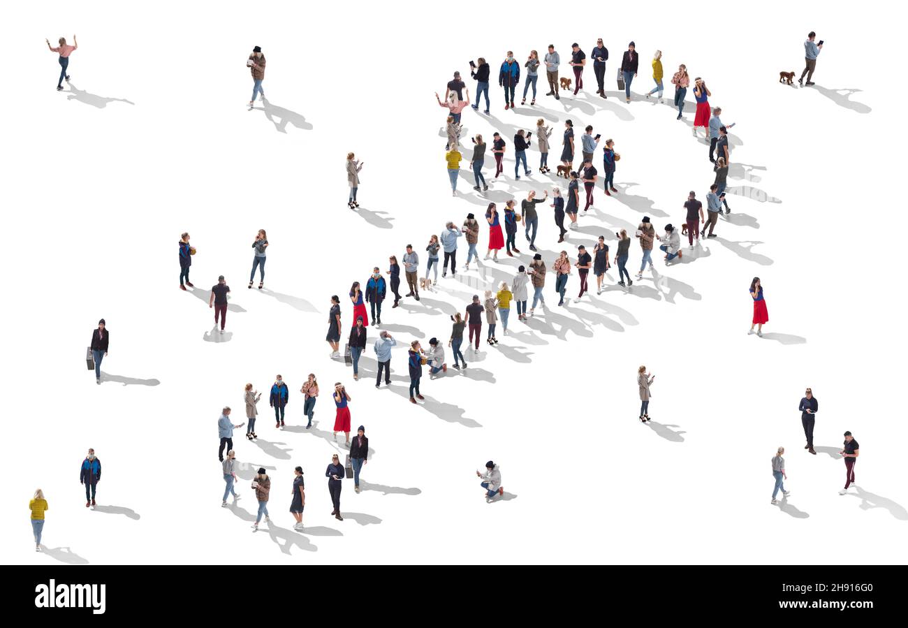 Aerial view of crowd of people standing in shape of question mark. Top ...