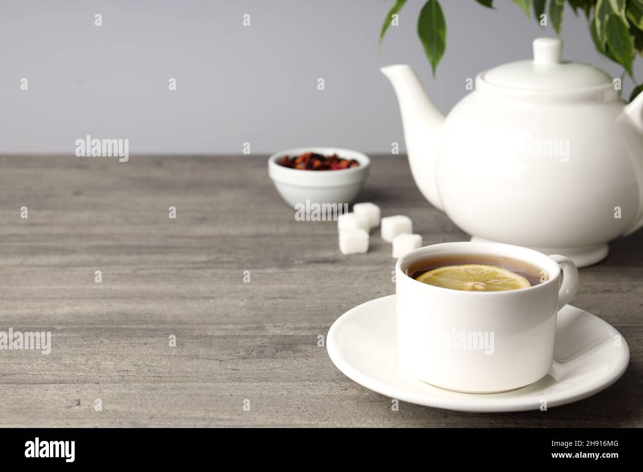 Concept of hot drink with tea on gray wooden table Stock Photo - Alamy