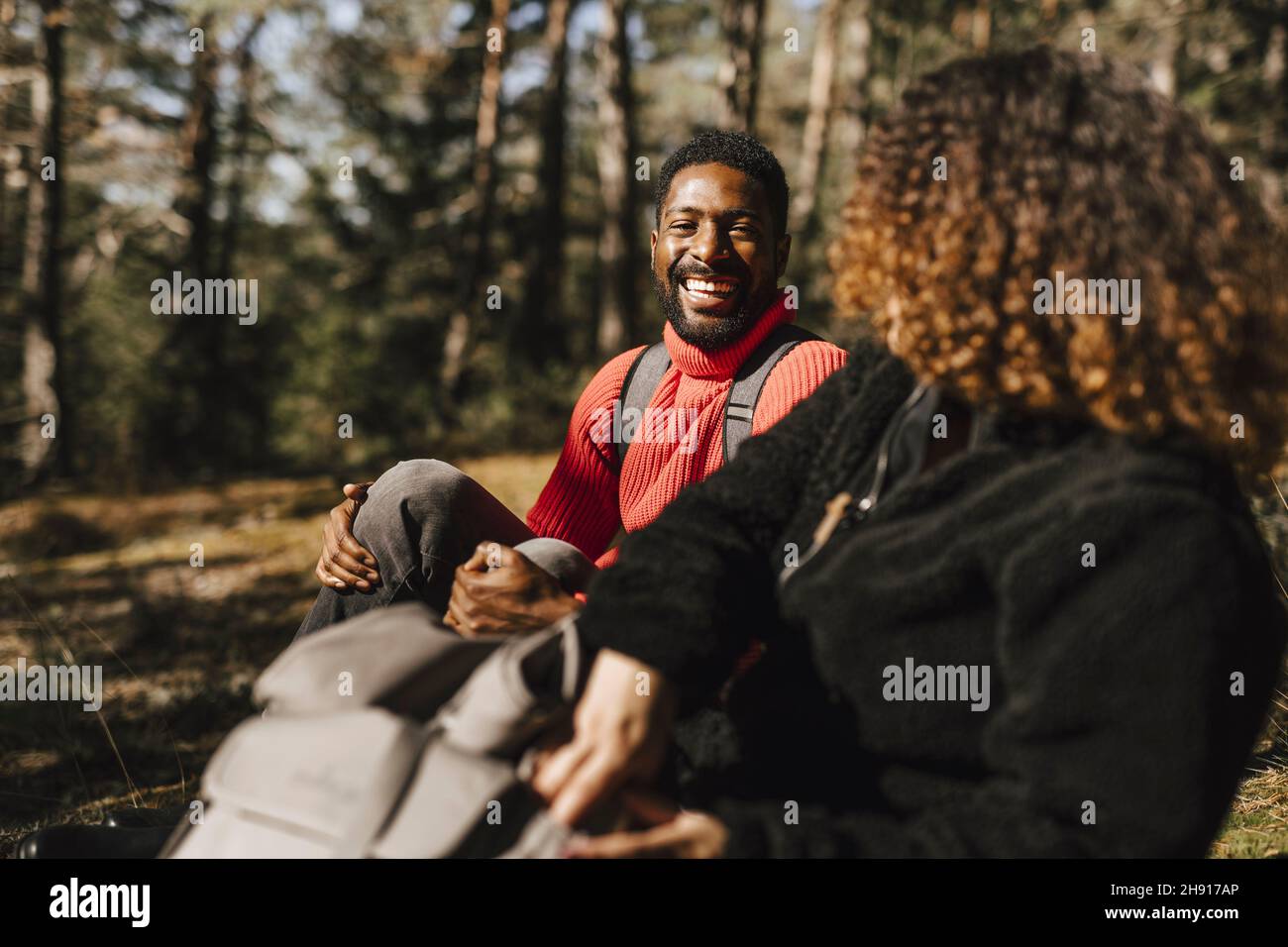 Happy man talking with girlfriend in forest during vacation Stock Photo ...