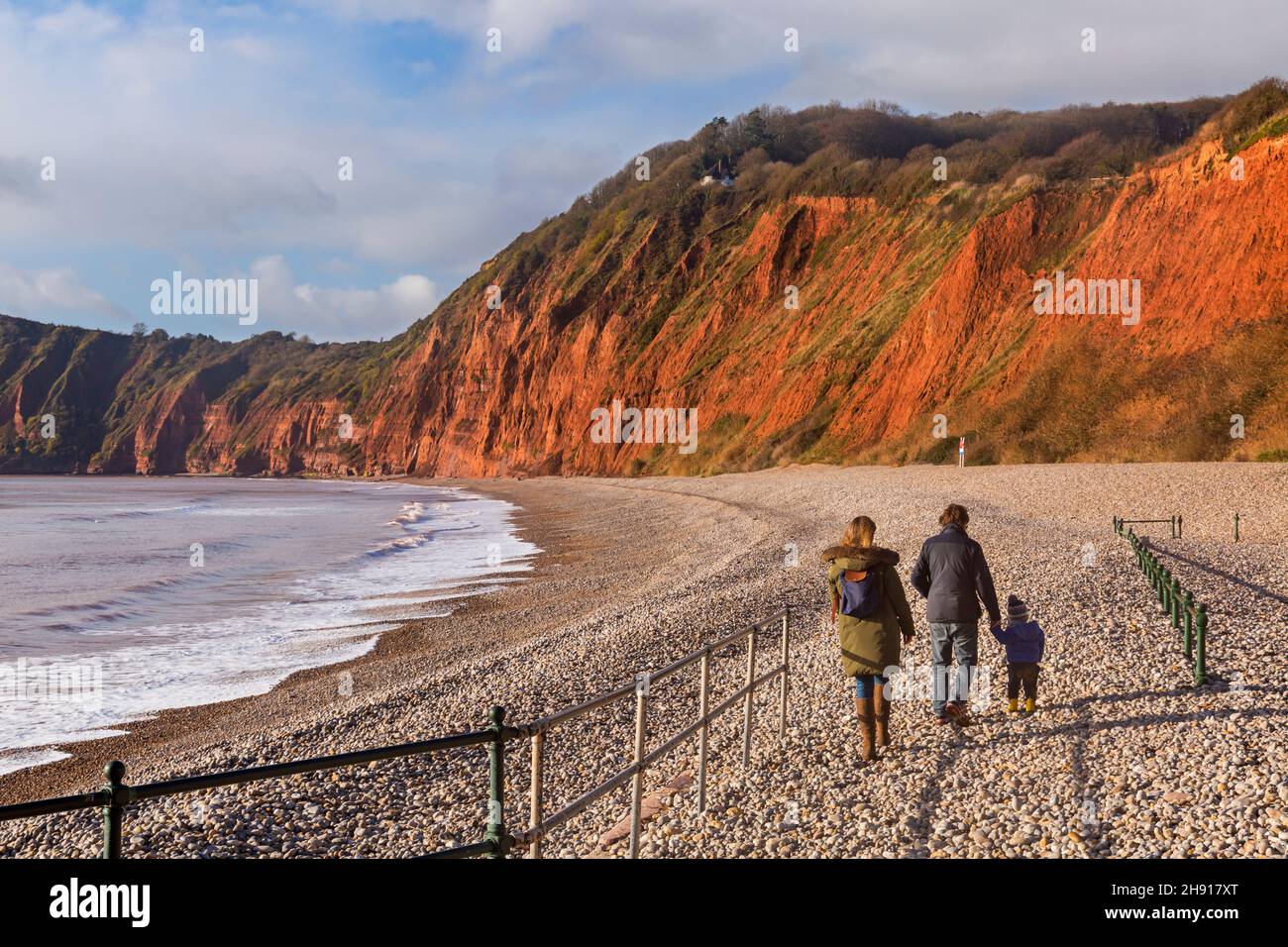 Family walking along Jacobs Ladder beach - seashore and cliffs of ...