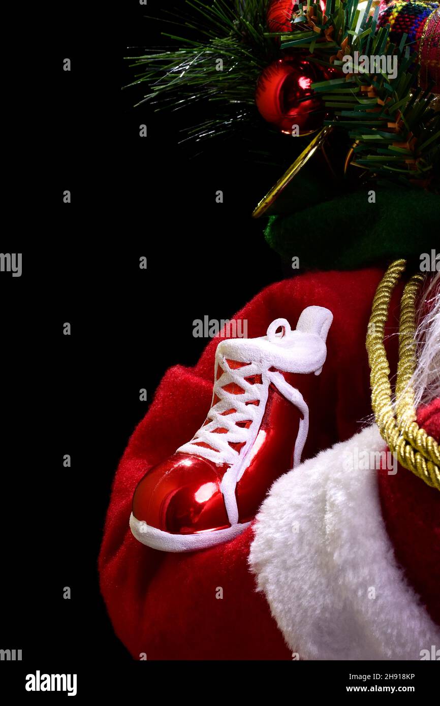 Shot of a red Christmas shoe on a Santa Claus arm and Christmas ...