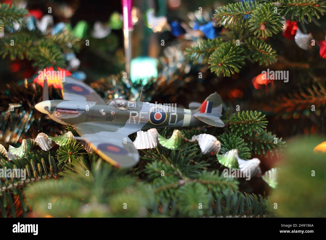 Vintage Christmas decorations including a model Spitfire Plane on a ...