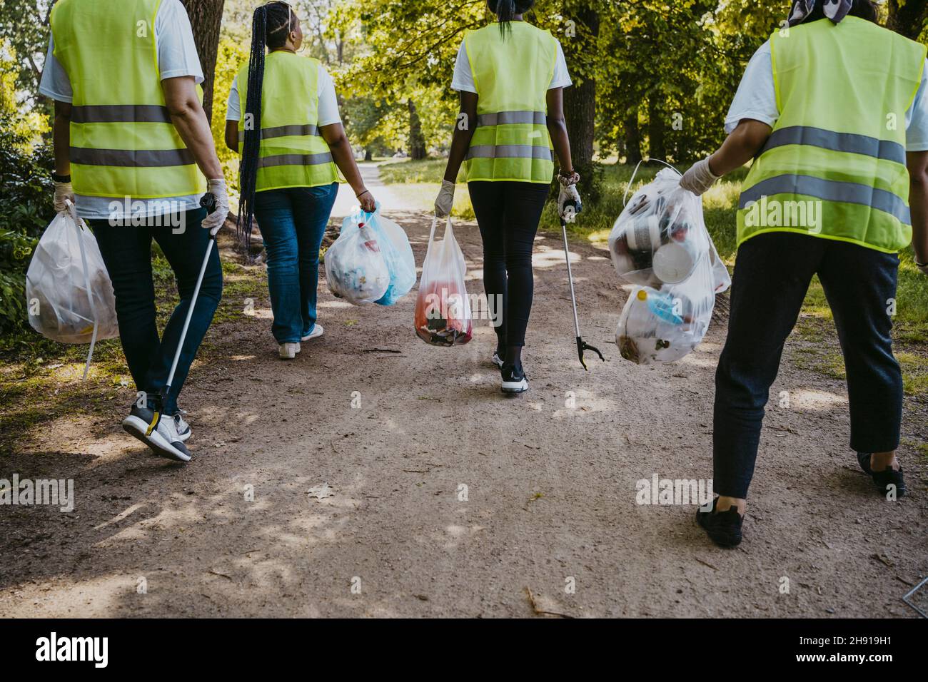 Female environmentalists with plastics in park Stock Photo - Alamy