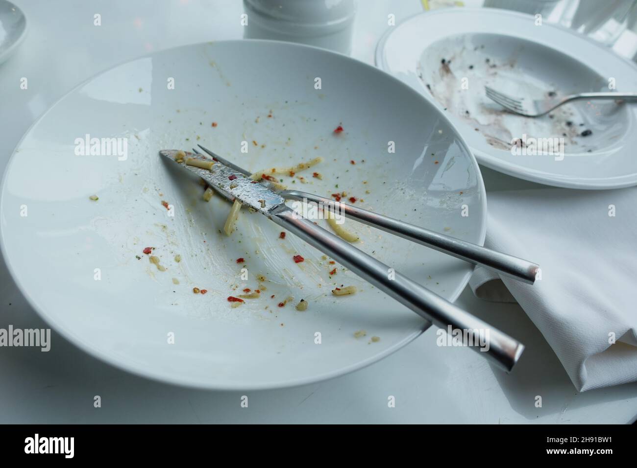 Empty plate after eating on table Stock Photo - Alamy