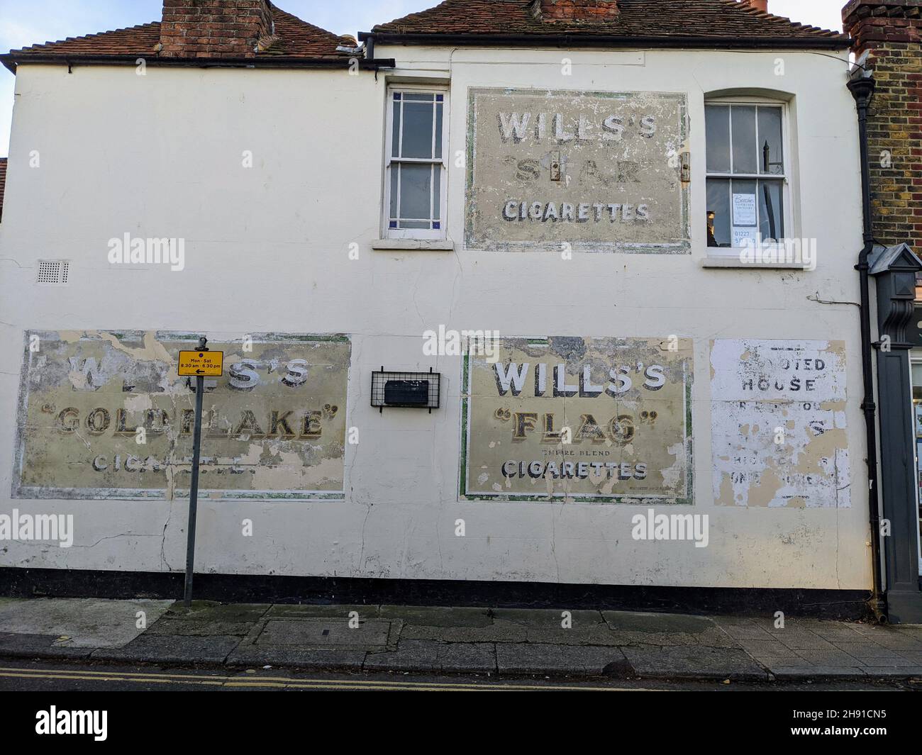 Ghost signs on the side of a building in Whitstable, Kent Stock Photo ...