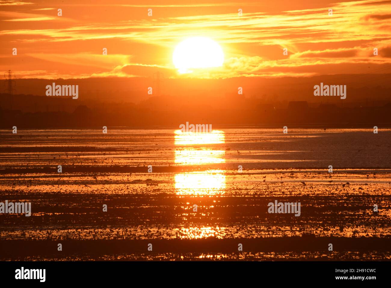 The sun sets in the west at the end of a beautiful November day in ...