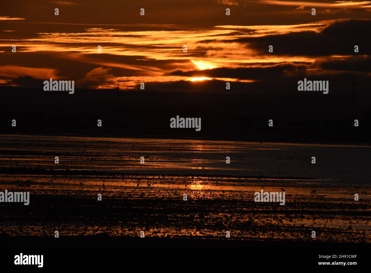 The sun sets in the west at the end of a beautiful November day in ...