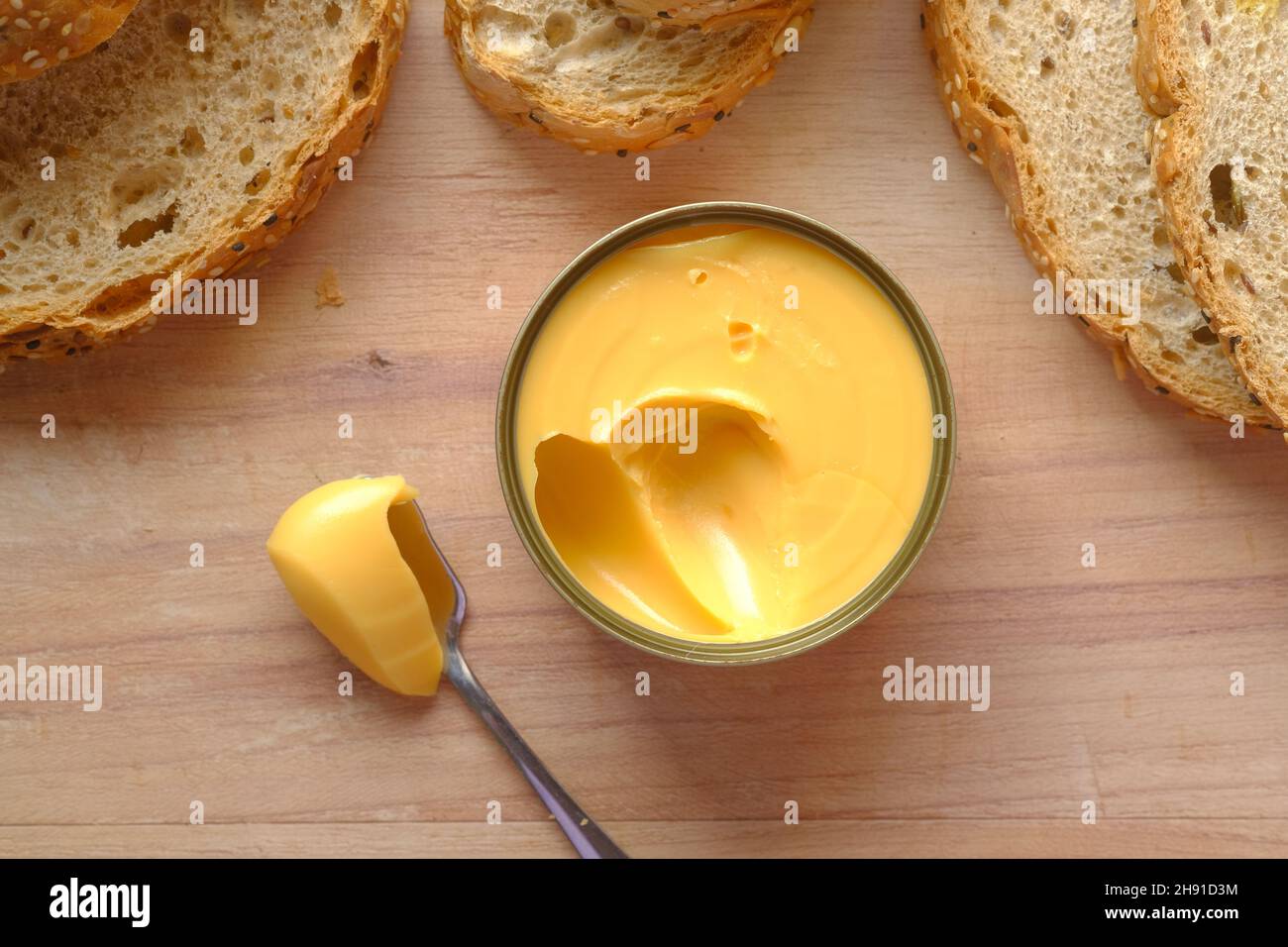 cheddar cheese in a tin container on table Stock Photo - Alamy