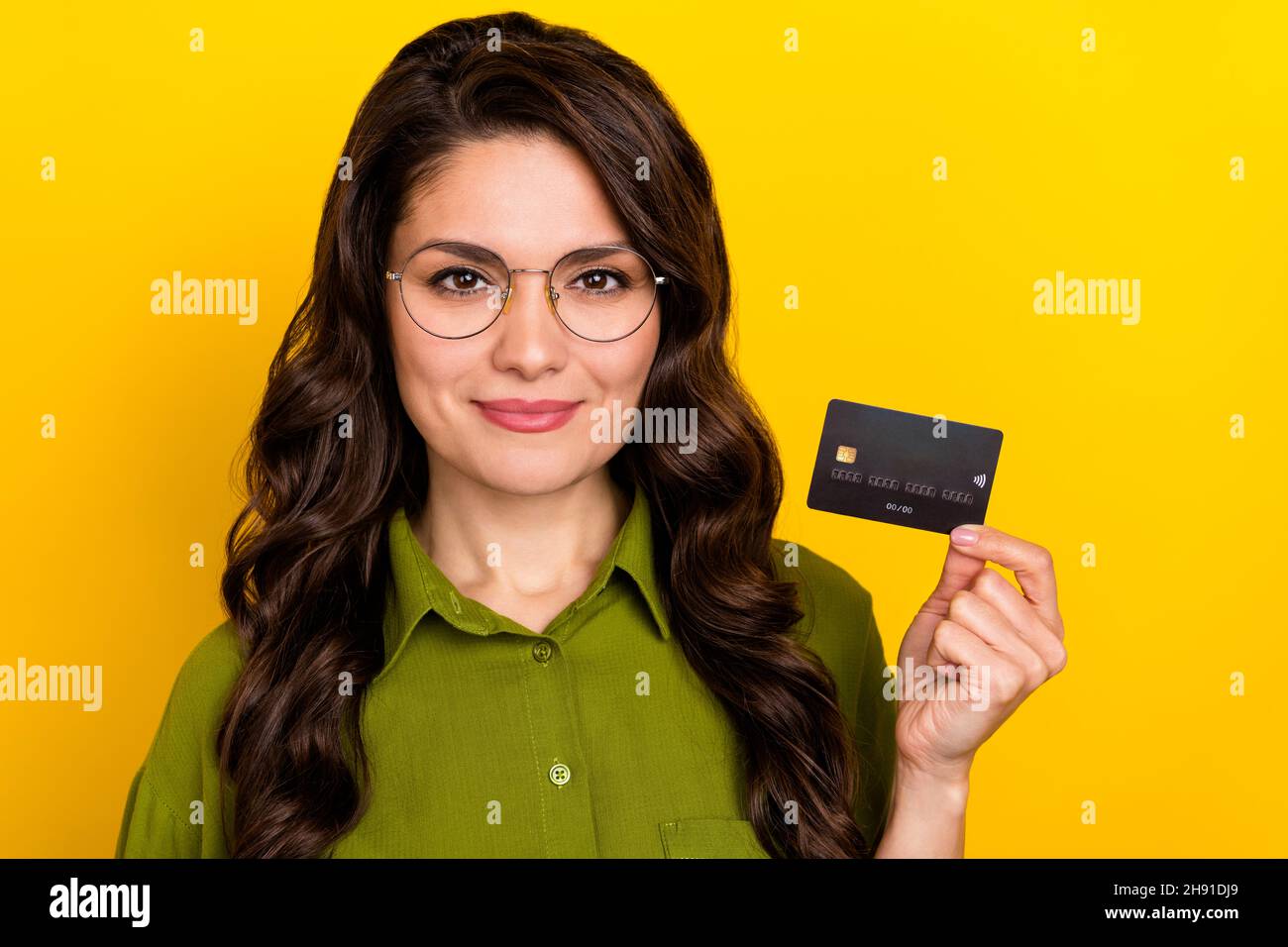 Photo of cheerful banker lady demonstrate debit card wear glasses green ...