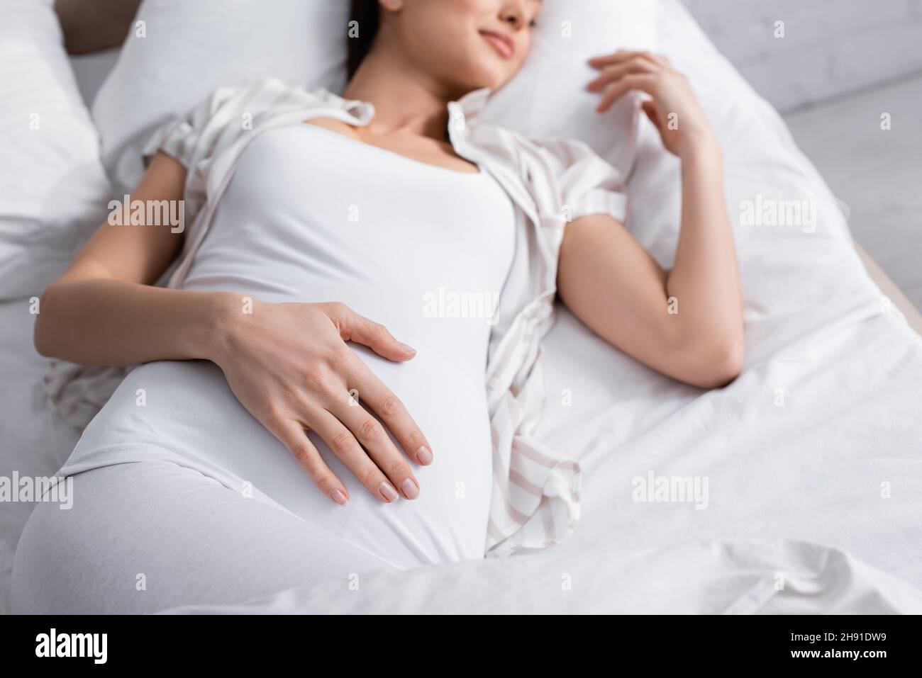 Pregnant woman in bed hi-res stock photography and images - Alamy
