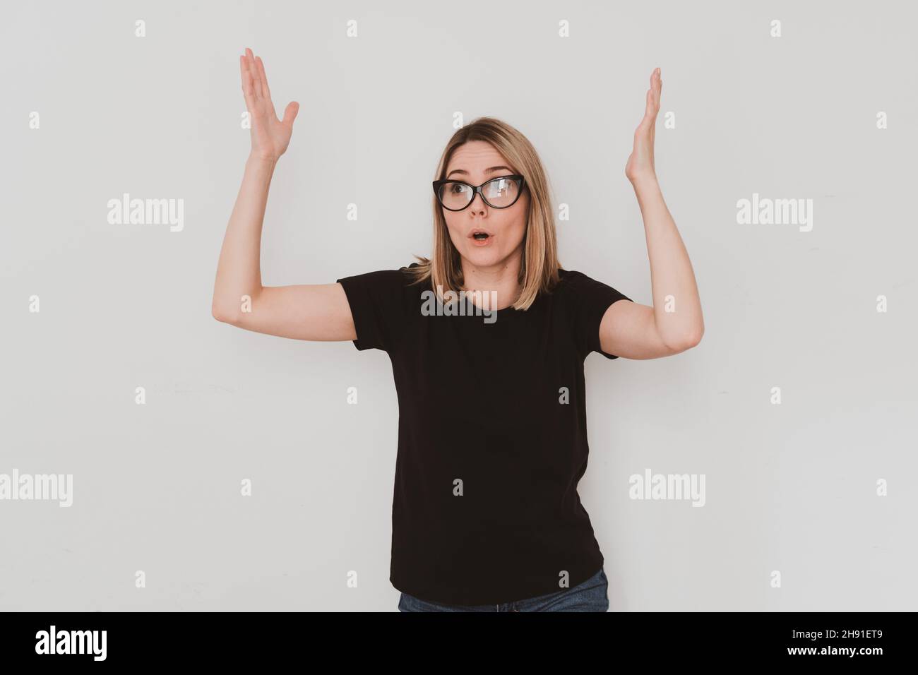 Portrait of surprised european woman in casual clothers and glasses ...