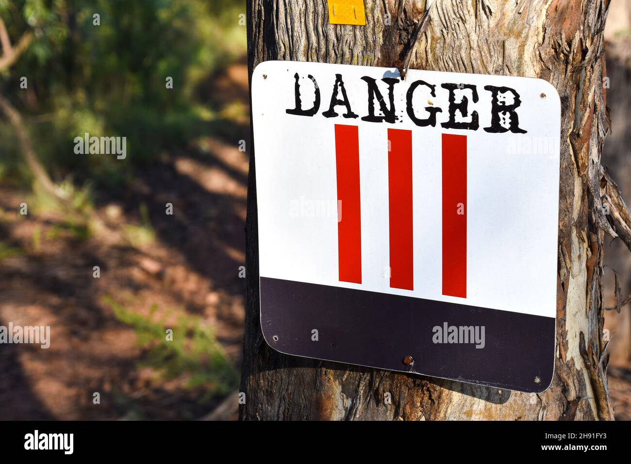 A danger sign with a unique design with black and red bright colors on ...