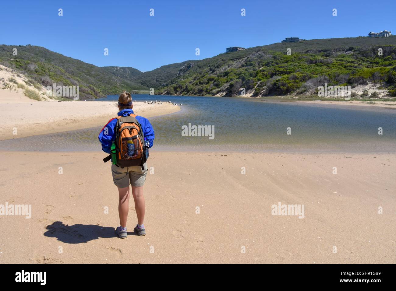 A female walker standing on the beach near the Indian Ocean seen from ...