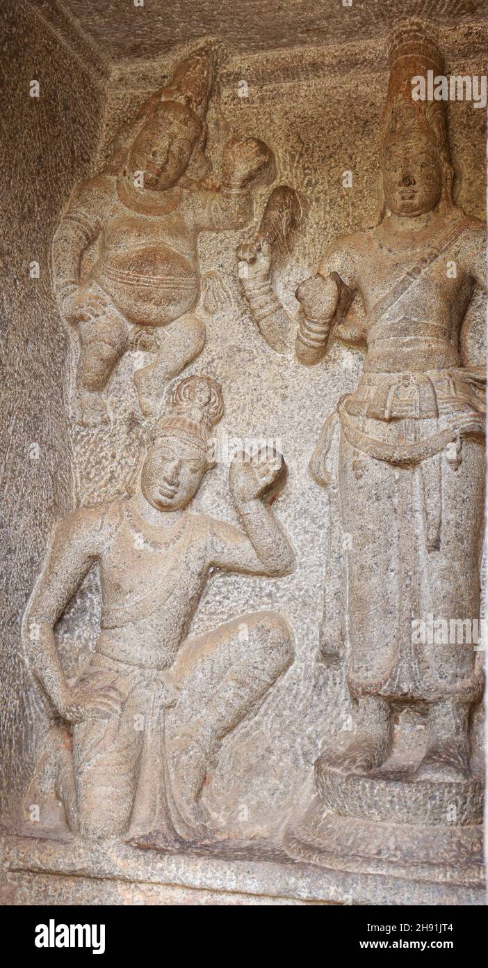 Statue of a Hindu god carved in stone. The rock is located in the ...