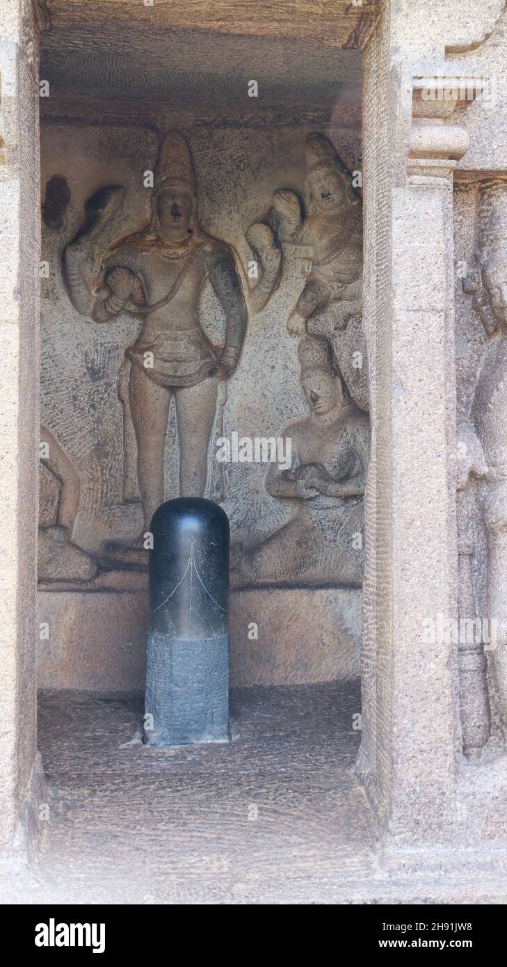 Statue of a Hindu god carved in stone. The rock is located in the ...