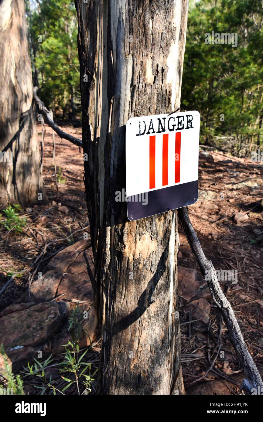 A danger sign with a unique design with black and red bright colors on ...