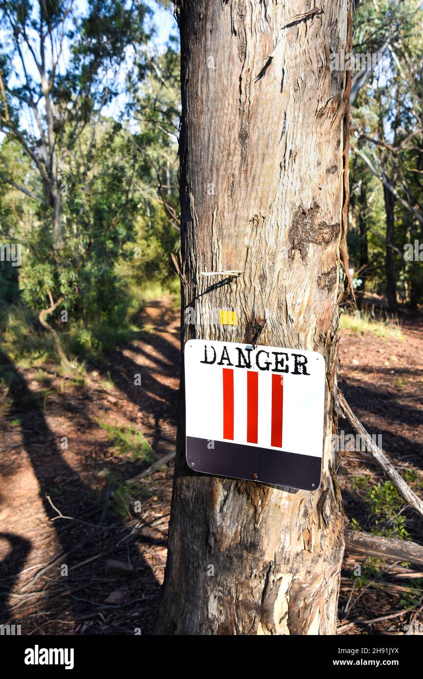 A danger sign with a unique design with black and red bright colors on ...