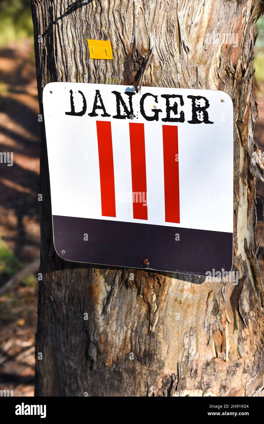 A danger sign with a unique design with black and red bright colors on ...