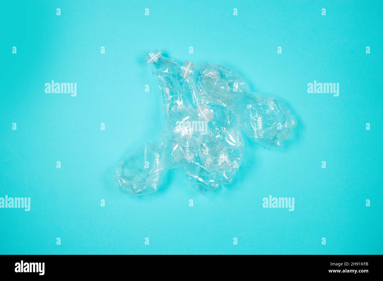 Used rumpled plastic bottles on a blue background. Ecology problem. Top ...