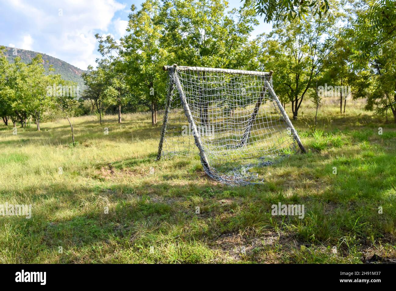 A climbing rack made of wooden poles and a net made for an obstacle ...