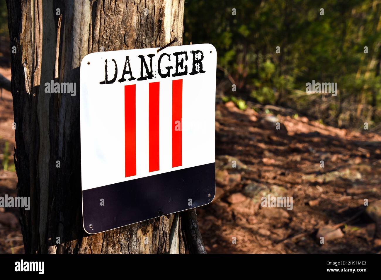 A danger sign with a unique design with black and red bright colors on ...