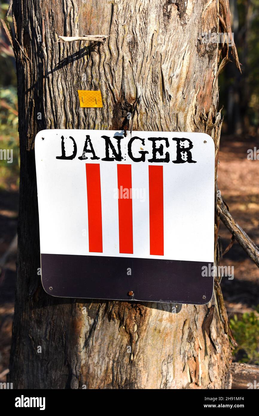A danger sign with a unique design with black and red bright colors on ...