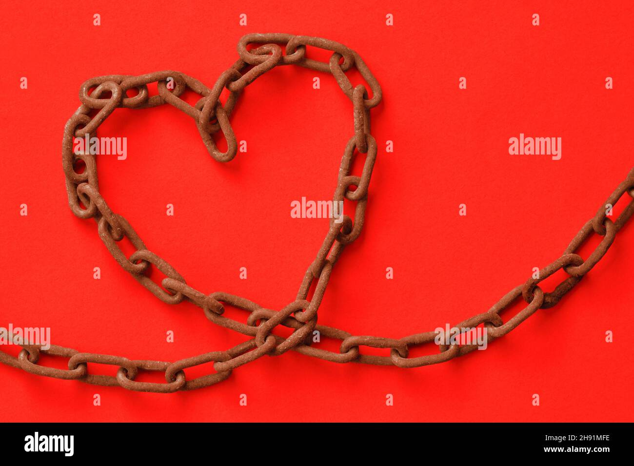 Heart made of iron chain on red background - Love and freedom concept ...