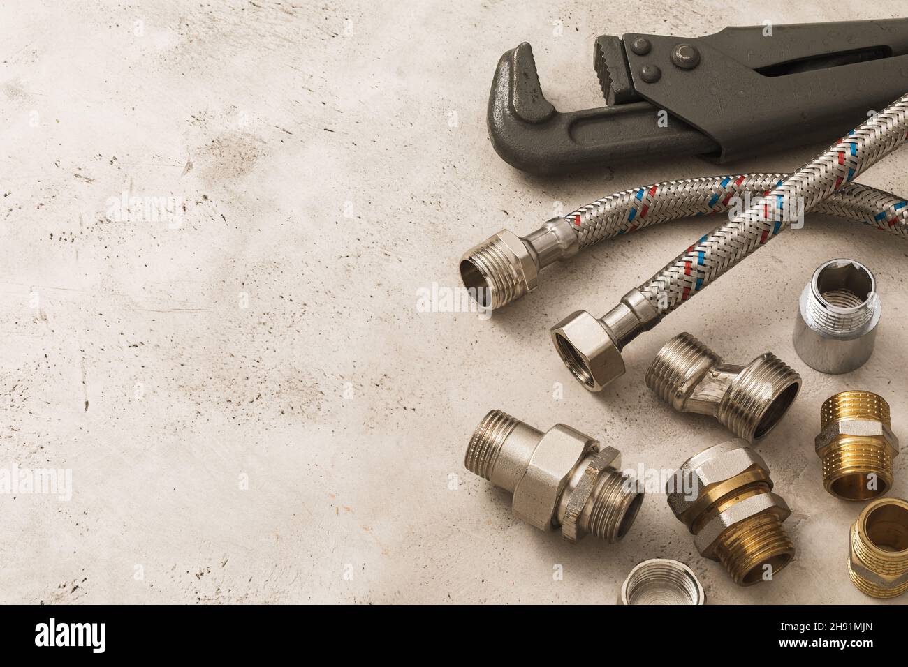 Adjustable wrench, flexible water hoses and connecting adapters on the ...