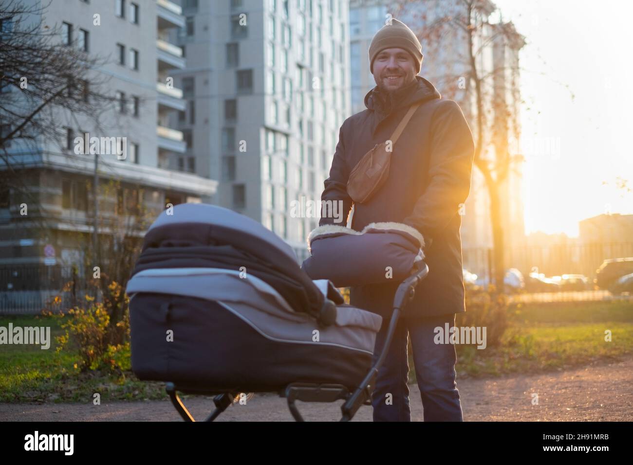 Happy young father with pram during the walk in nature Stock Photo - Alamy
