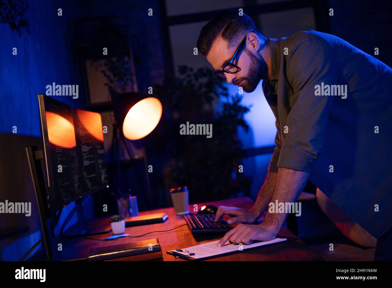 Profile photo of serious skilled guy read papers write email keyboard ...