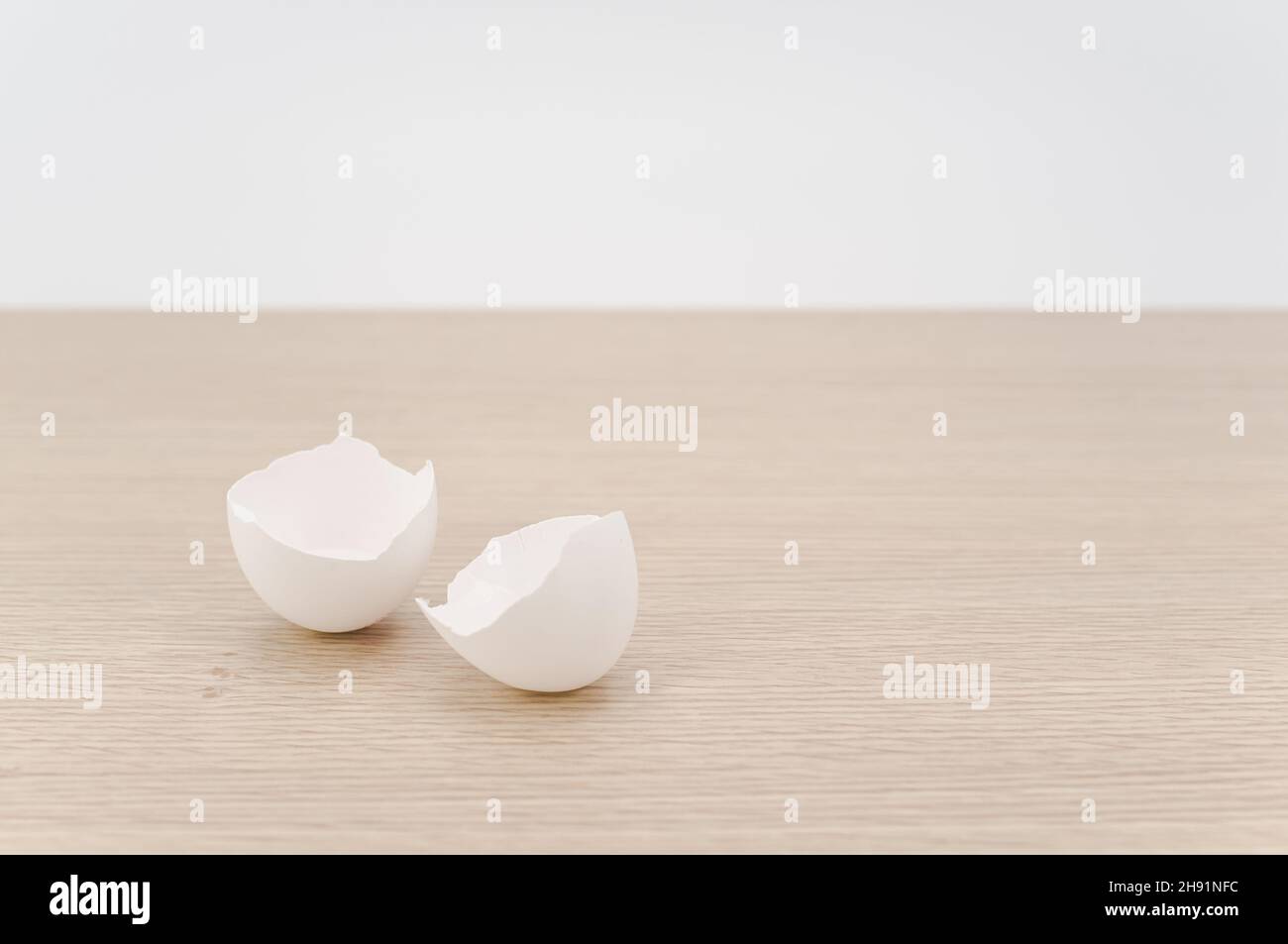 isolated white egg shells on a rustic wooden background with text space ...