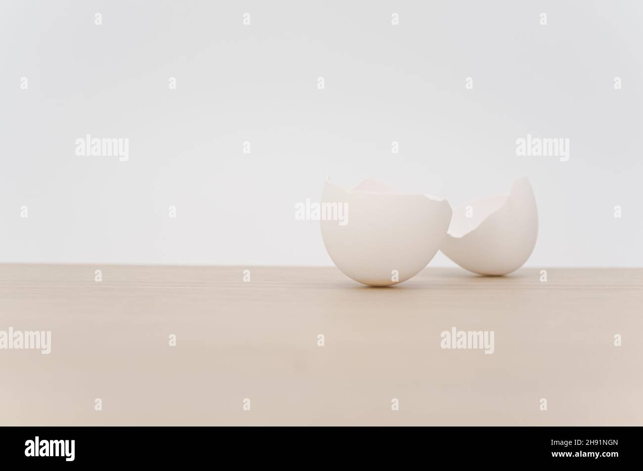 isolated white egg shells on a rustic wooden background with text space ...