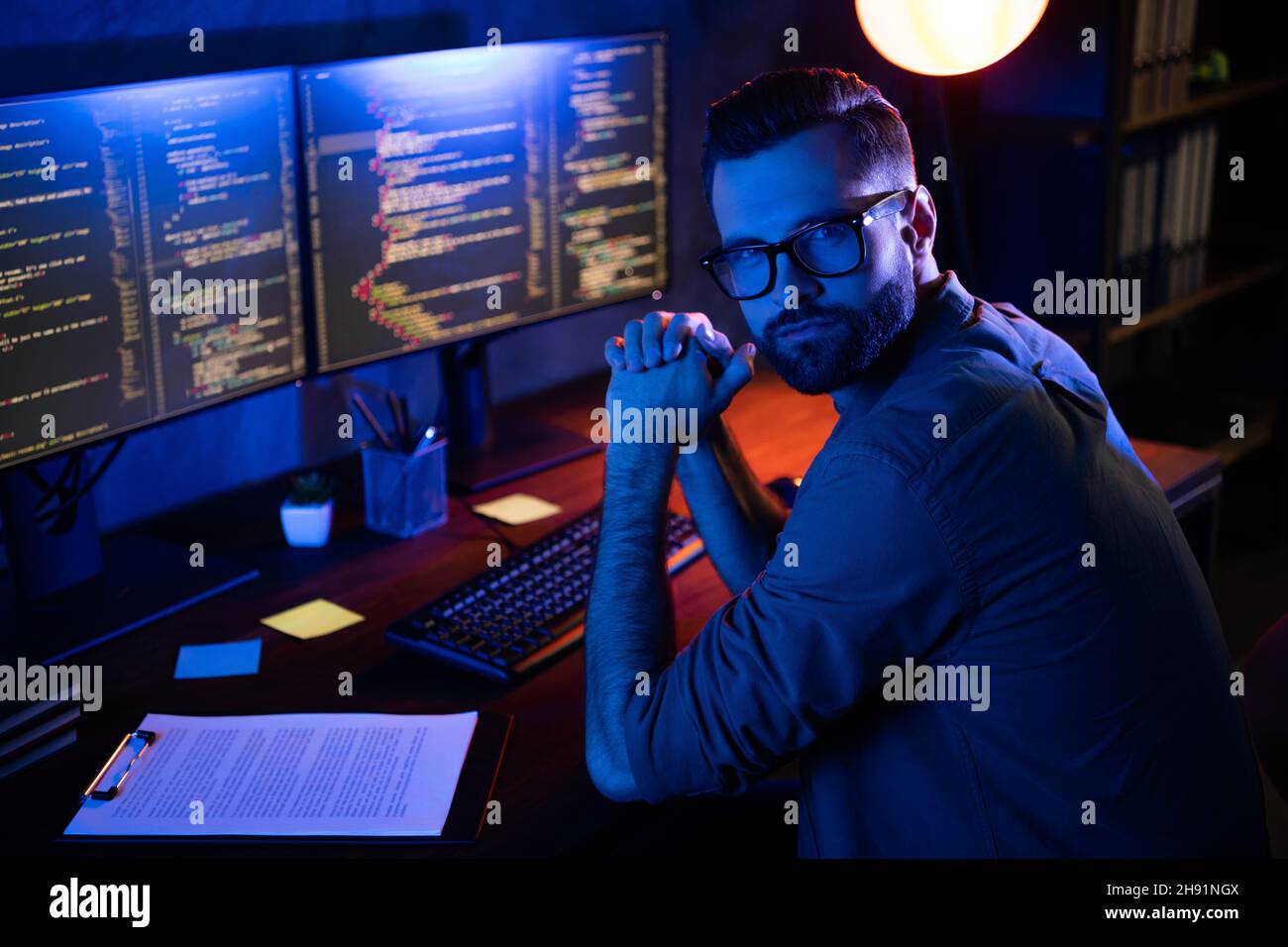 Photo of serious professional programmer look camera improving ...