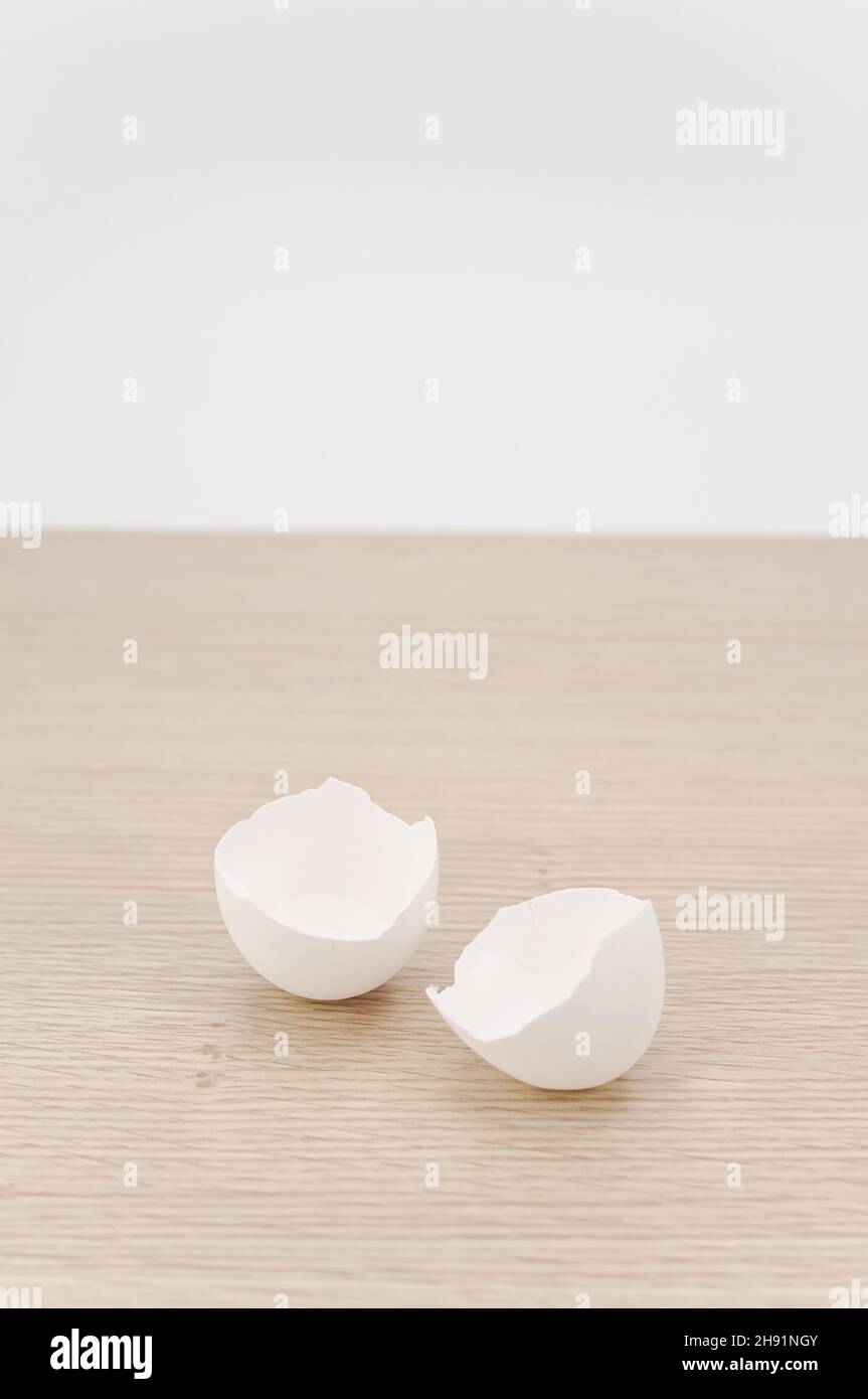 isolated white egg shells on a rustic wooden background with text space ...