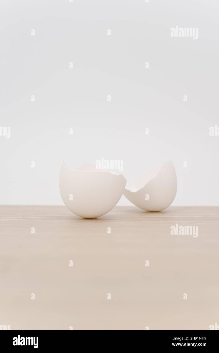 isolated white egg shells on a rustic wooden background with text space ...