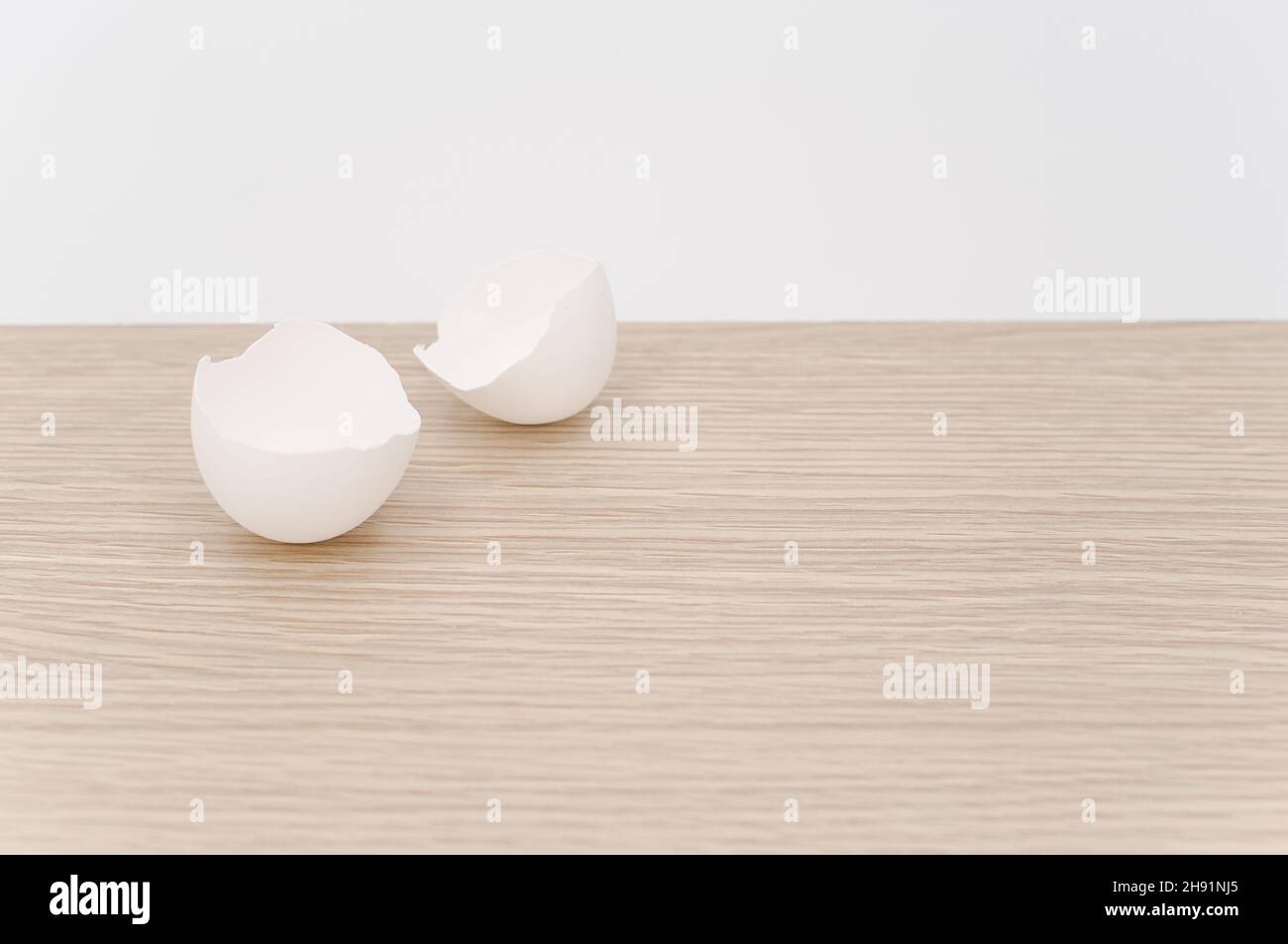 isolated white egg shells on a rustic wooden background with text space ...