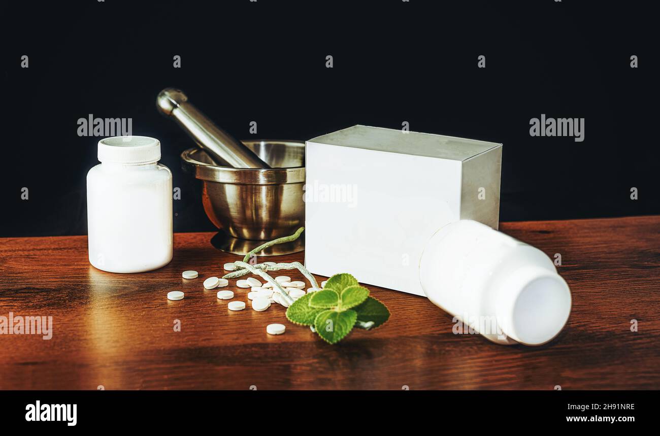 medicines on wooden table, black background Stock Photo - Alamy