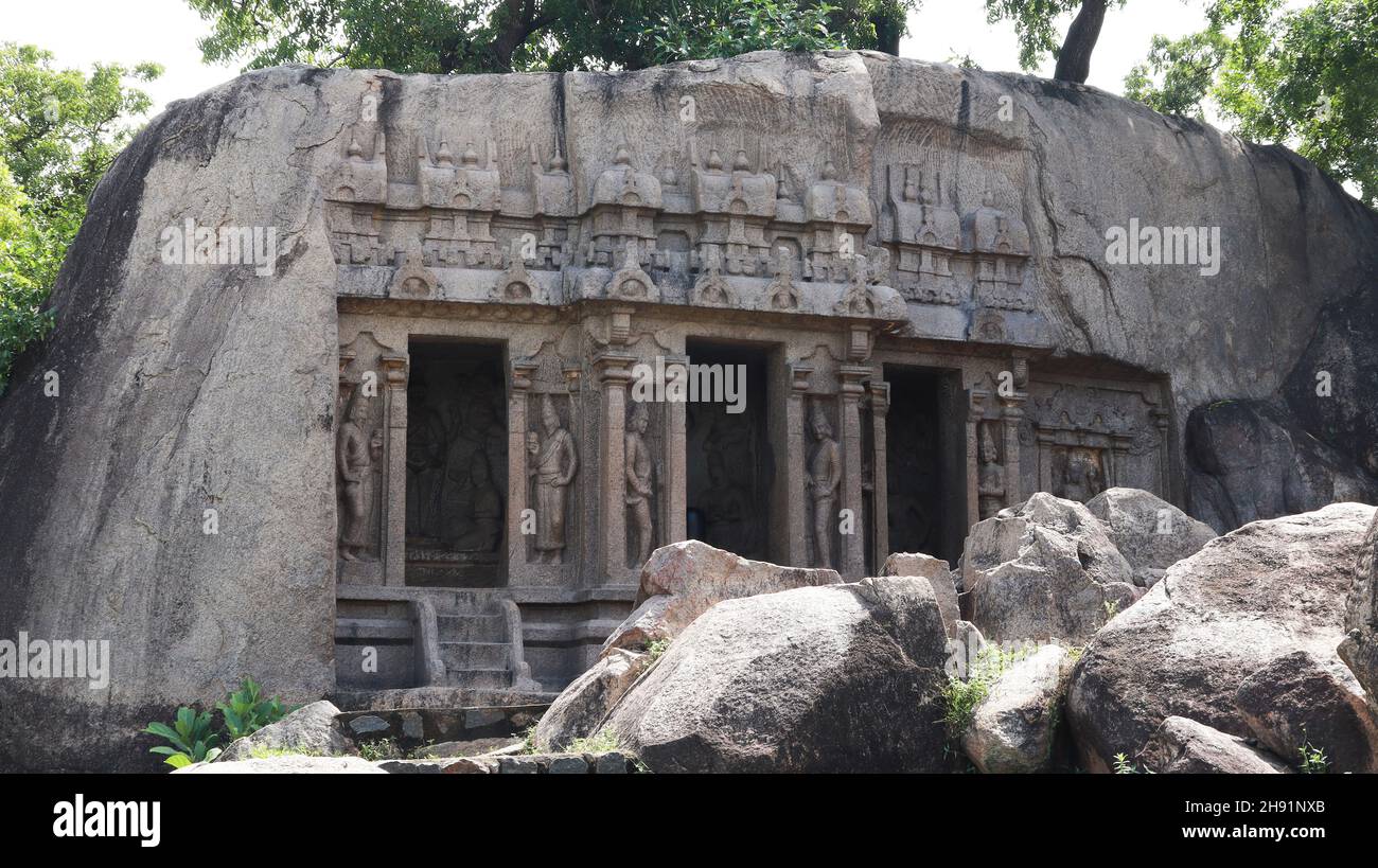 The cave temple is carved in stone and has sculptures and statues ...