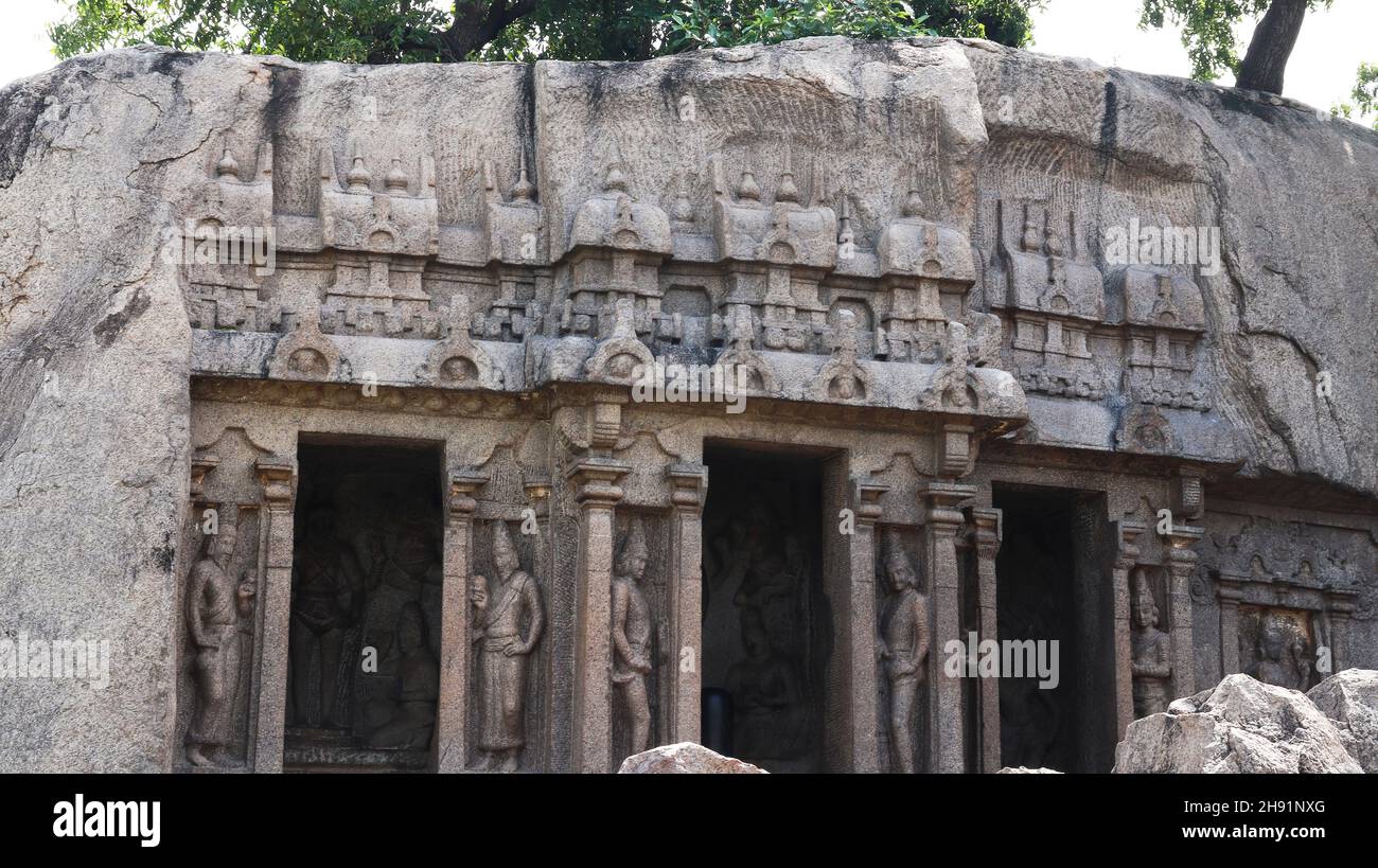 The cave temple is carved in stone and has sculptures and statues ...