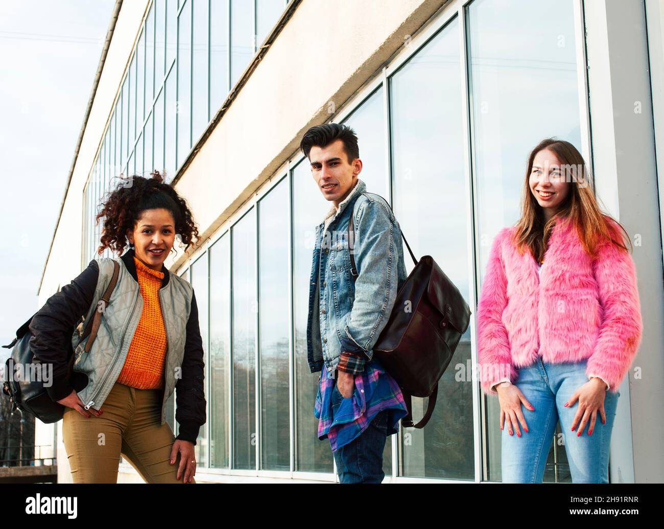 cute group of teenages at the building of university with books ...