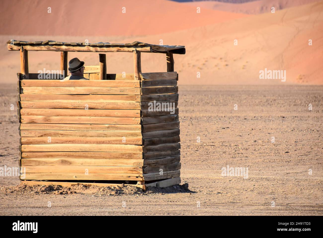 A tourist in a wooden structure near the famous sand dunes in the Namib ...