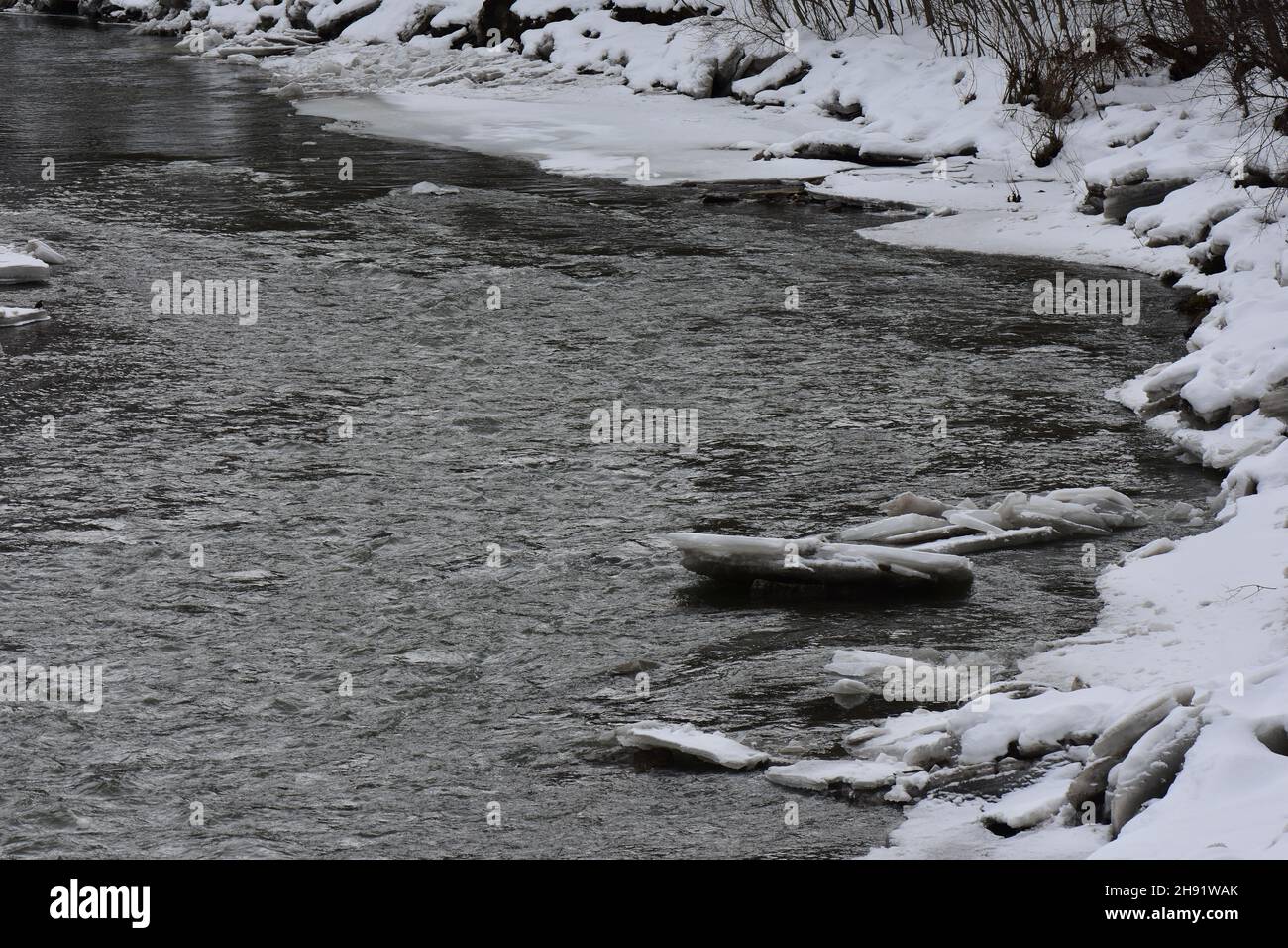 Chilling view of a mountain river flowing downstream during winter ...