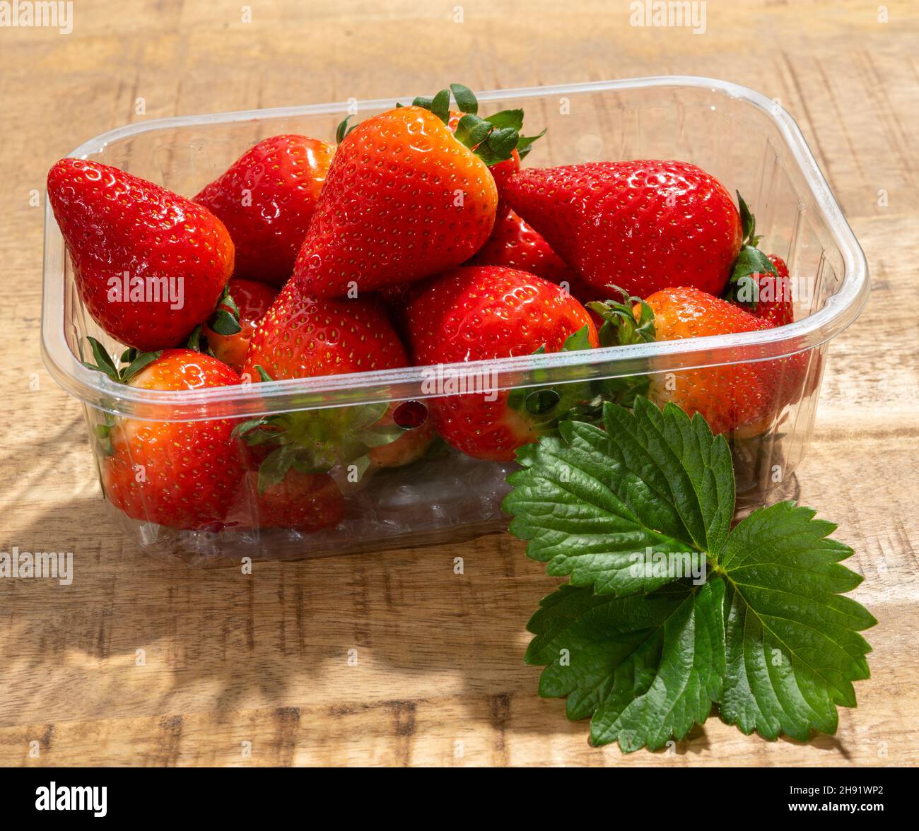 New harvest, plastic box of ripe red sweet strawberry ready to eat ...