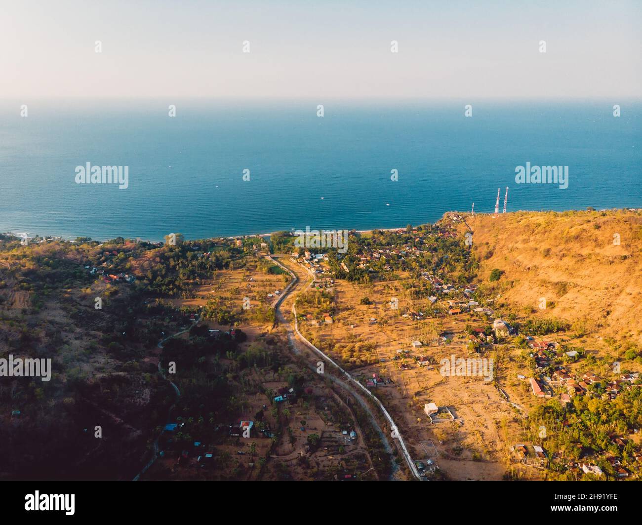 Aerial view of Amed village with sea and evening sunlight in Bali Stock ...